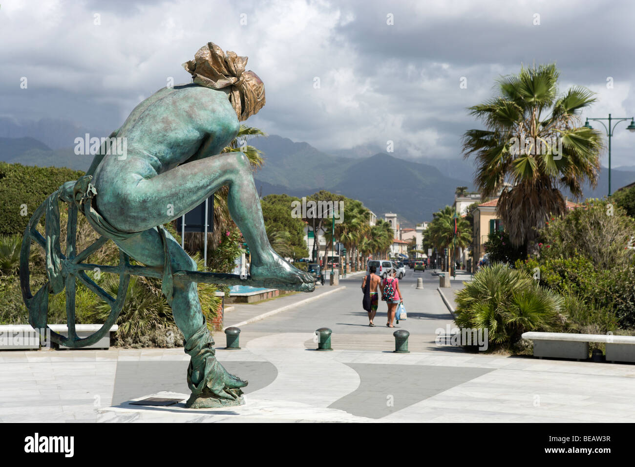 Statue on the seafront looking towards the mountains and resort centre ...