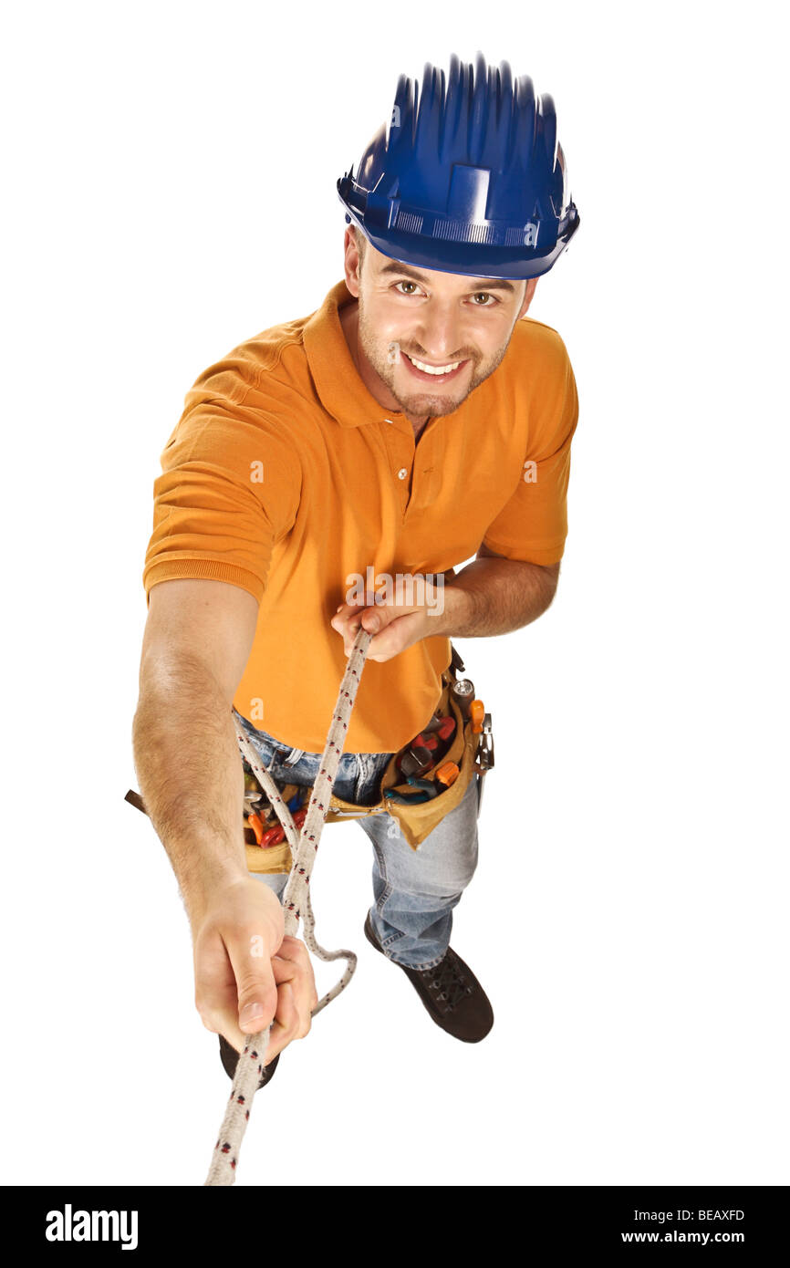 isolated young caucasian handyman pull rope and smiling Stock Photo - Alamy