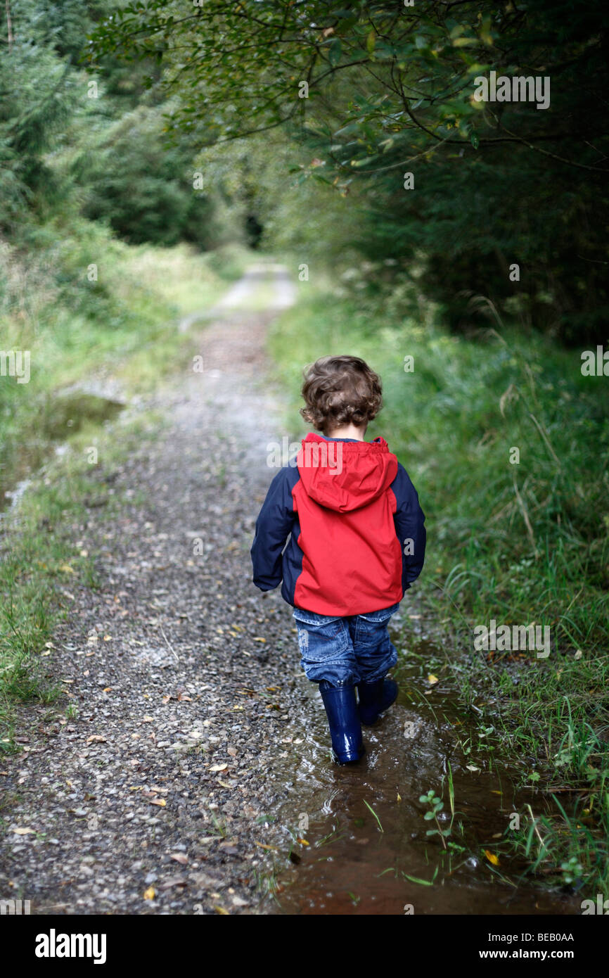 Young Boy Walking Down Rural Path Stock Photo - Alamy