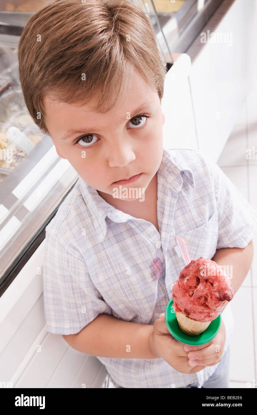 Portrait of a boy holding an ice cream Stock Photo - Alamy