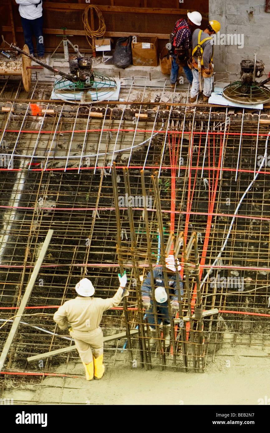 Construction workers working at a construction site Stock Photo - Alamy