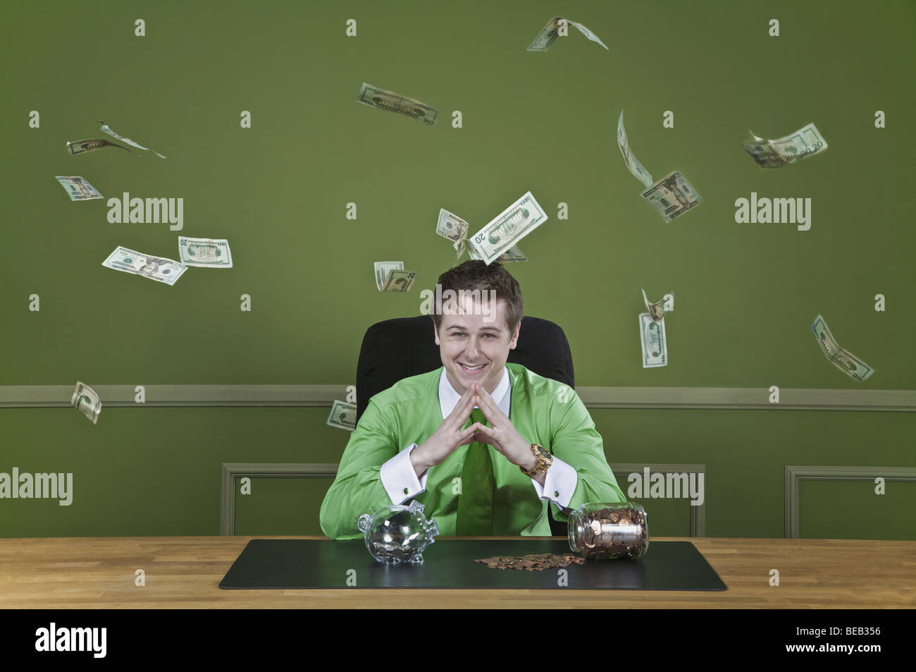 Currency notes falling over a businessman Stock Photo - Alamy