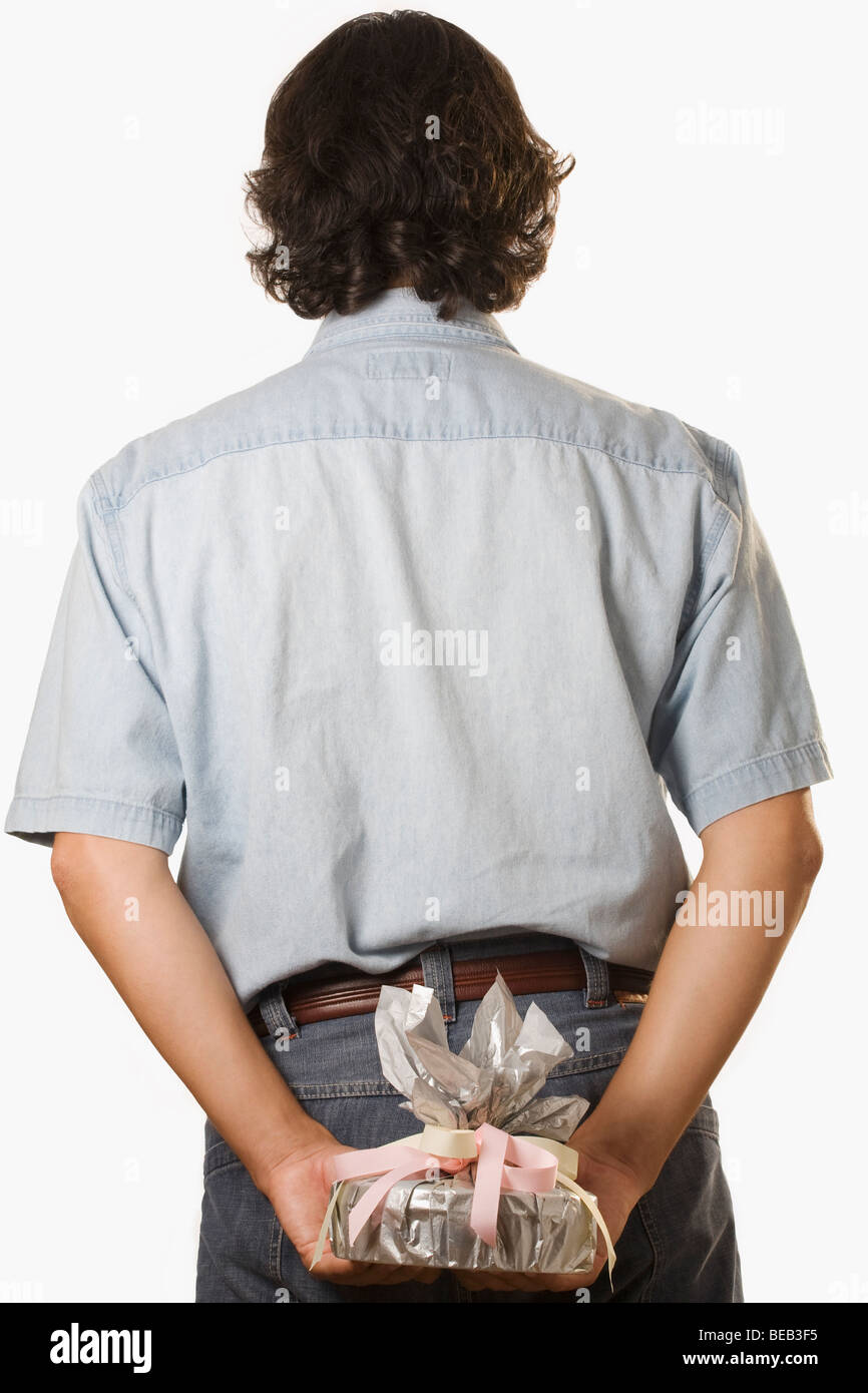 Man standing hiding present box hi-res stock photography and images - Alamy
