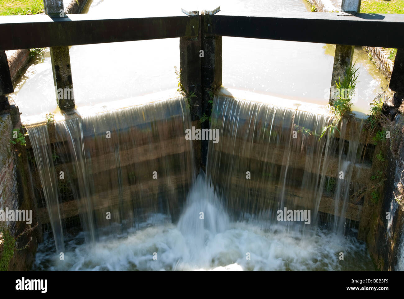 River water pouring over closed lock gates Stock Photo - Alamy