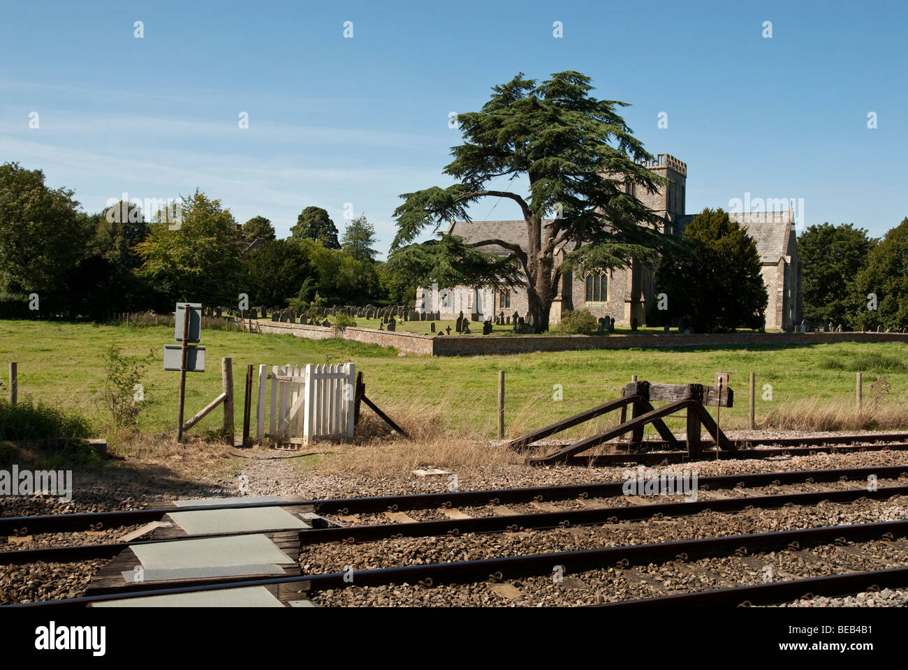 church and railway line with pedestrial crossing Stock Photo - Alamy
