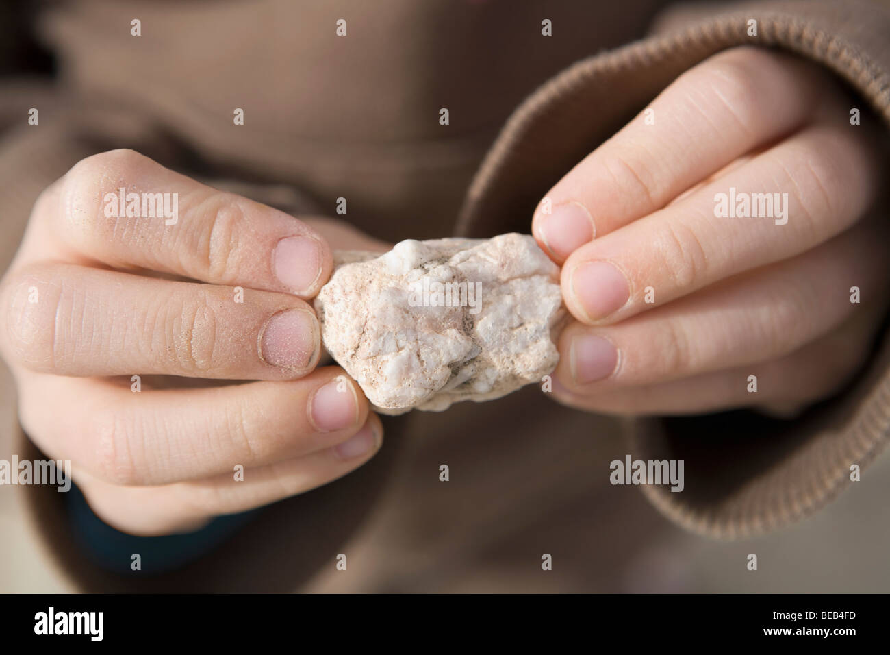 Child holding a stone hi-res stock photography and images - Alamy