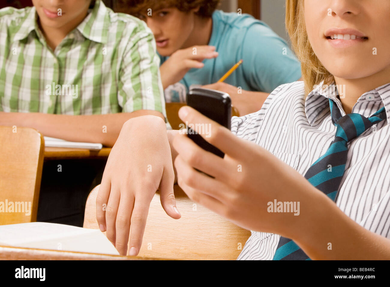 Teenager in a classroom on her phone hi-res stock photography and ...