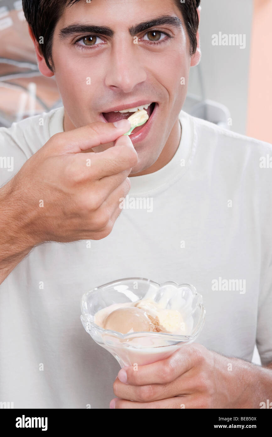 Portrait of a man eating an ice cream Stock Photo - Alamy