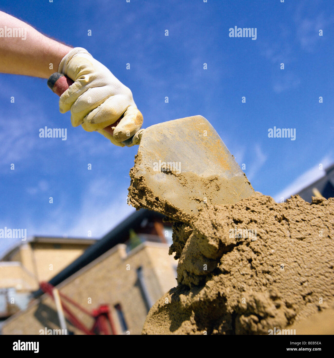 Bricklayer applying cement onto bricks Stock Photo - Alamy