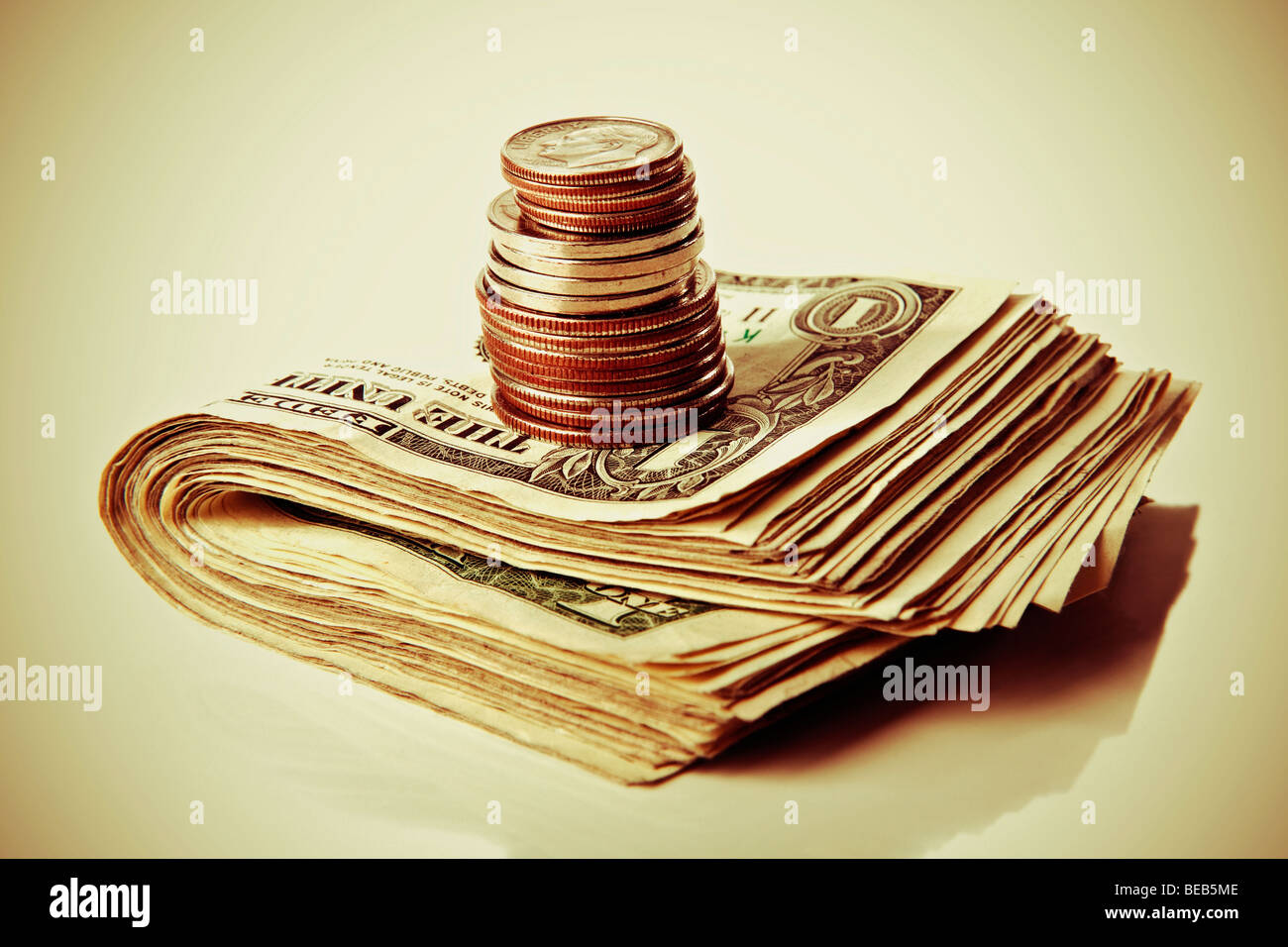 Close-up of a stack of coins on stack of US dollar bills Stock Photo ...