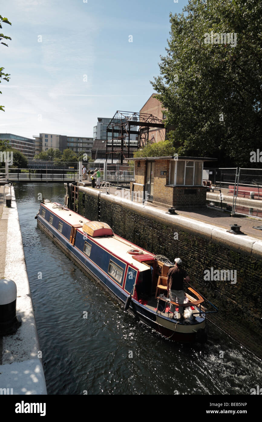 A canal boat leaves the Old Ford Lock on the River Lee Navigation near ...