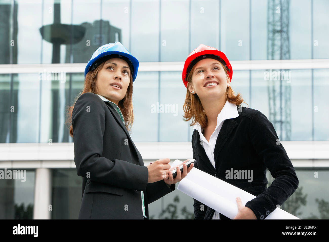 Young women on a construction site wearing a hard hat Stock Photo - Alamy