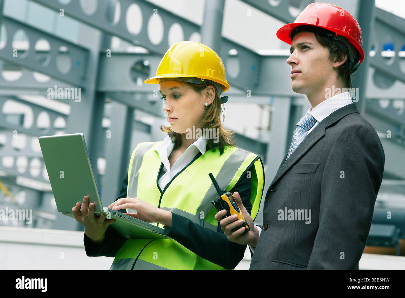 Construction managers on site with computer Stock Photo - Alamy