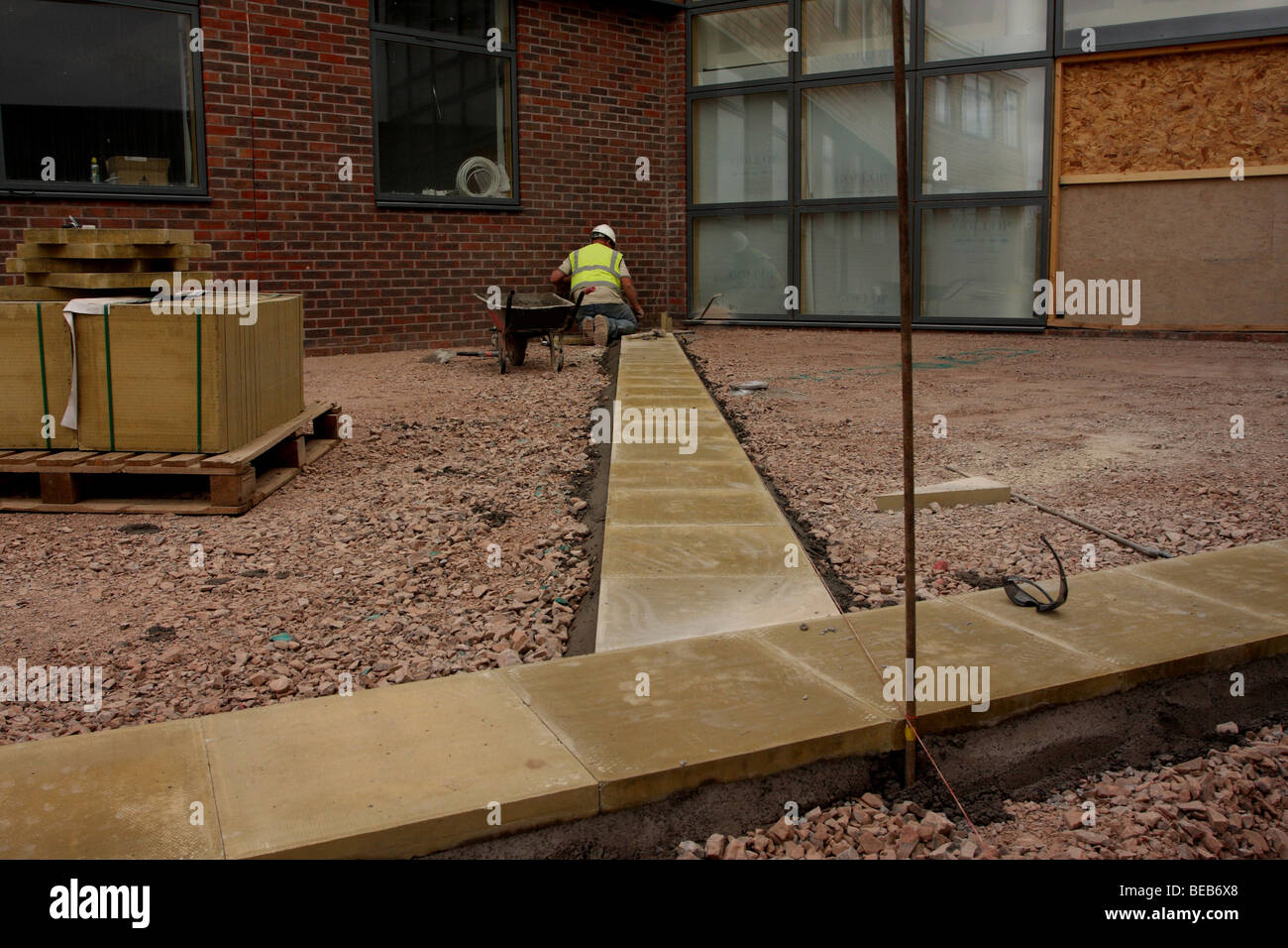 Contractor laying decorative paving in a patten Stock Photo - Alamy