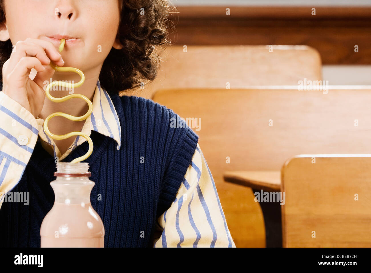 Schoolboy drinking chocolate milkshake in a classroom Stock Photo - Alamy