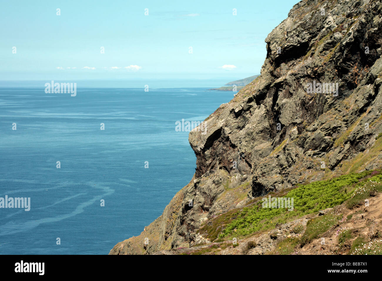 Face of a man in the cliff face against a blue ocean backdrop Stock ...