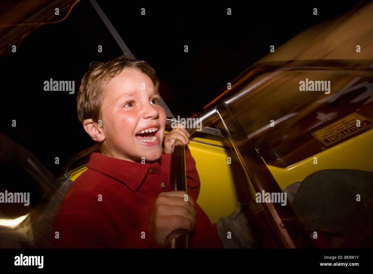 Boy riding on a carousel Stock Photo - Alamy