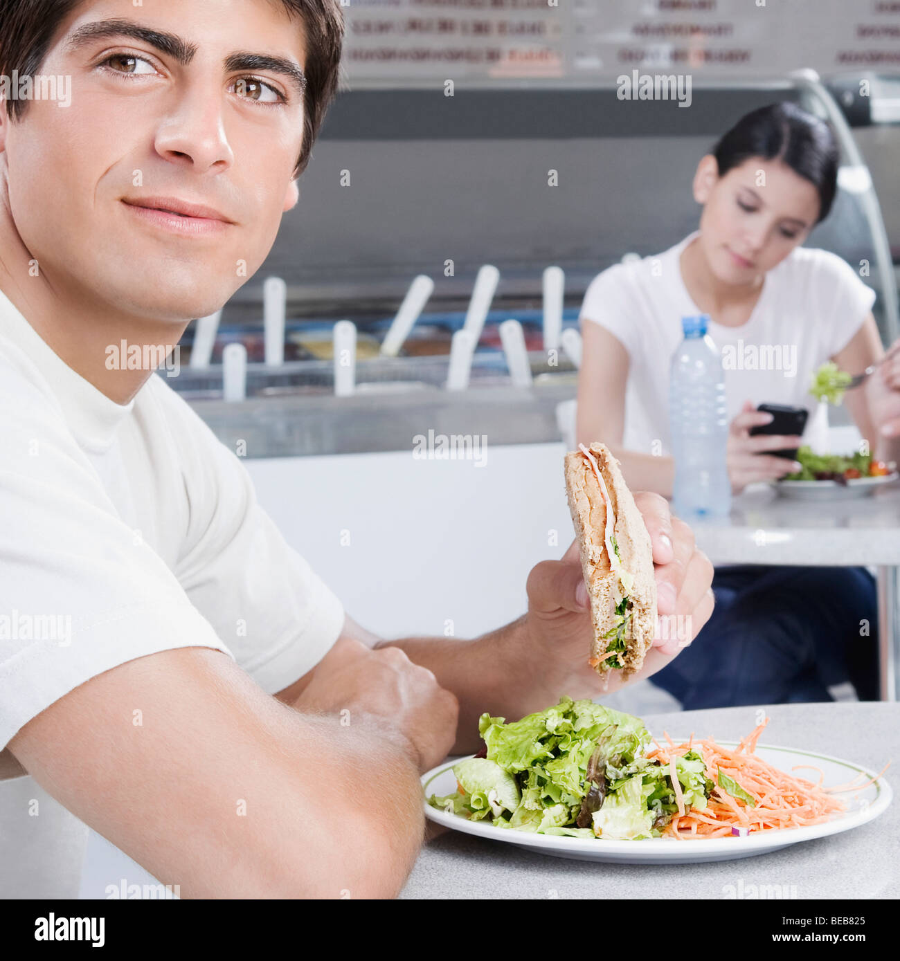 Man eating a sandwich in a restaurant Stock Photo - Alamy
