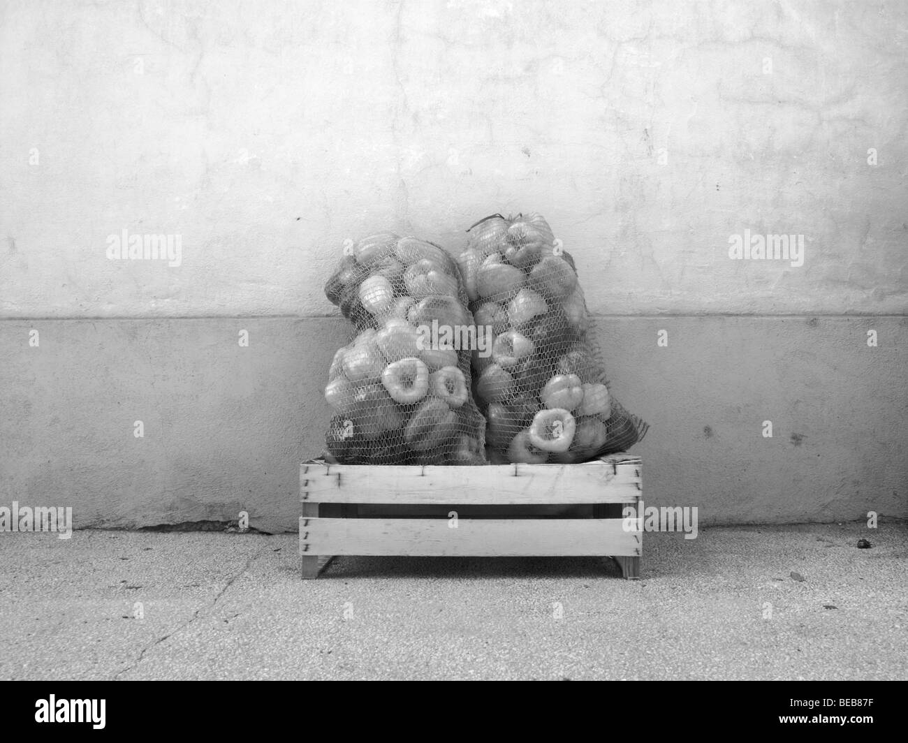 A box of yellow peppers against a grey wall Stock Photo - Alamy