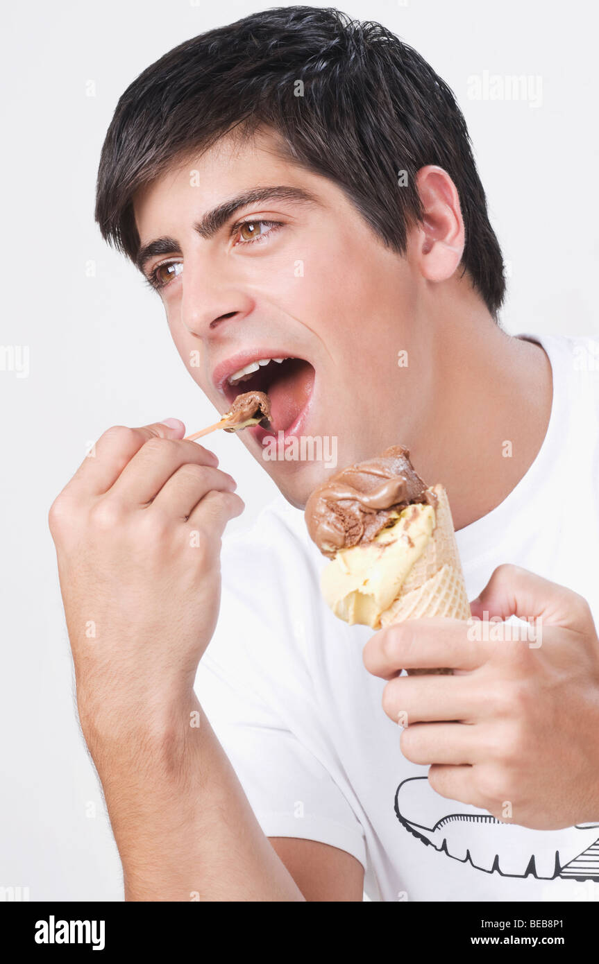 Close-up of a man eating an ice cream Stock Photo - Alamy