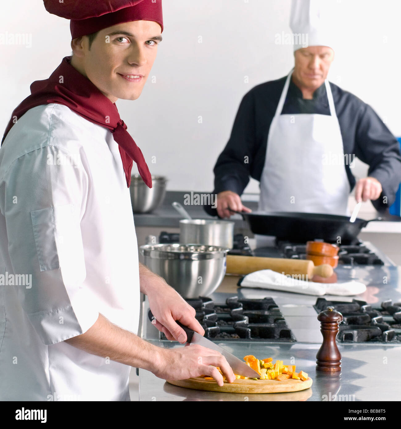 Two chefs cooking food in the kitchen Stock Photo - Alamy