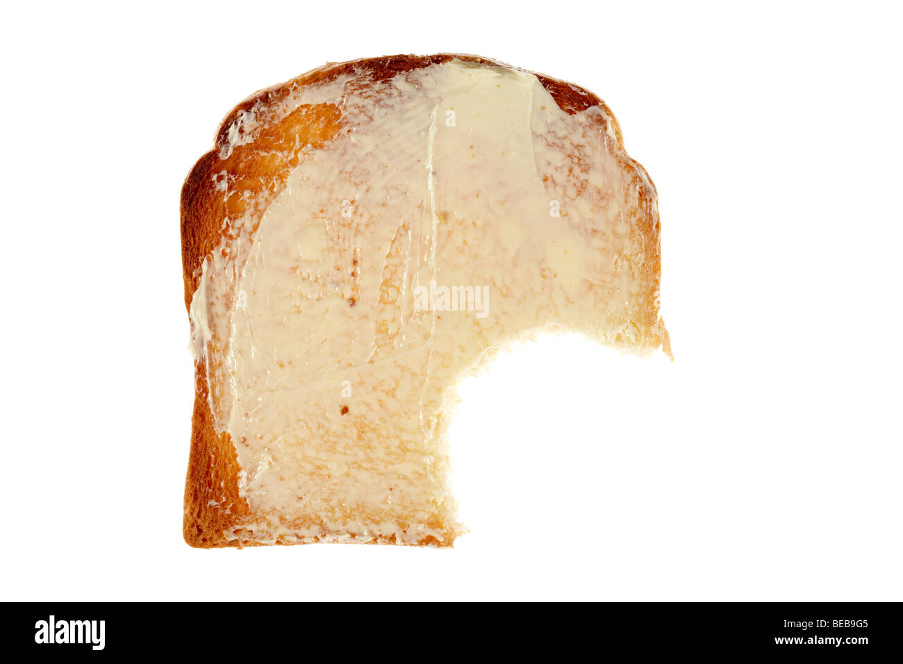 Buttered toast with a bite missing Stock Photo - Alamy