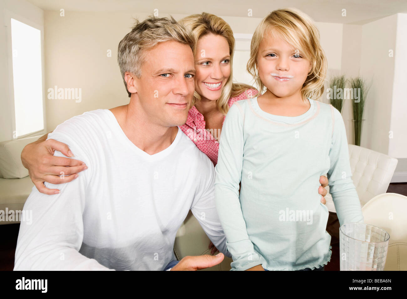 Couple with their daughter smiling Stock Photo - Alamy