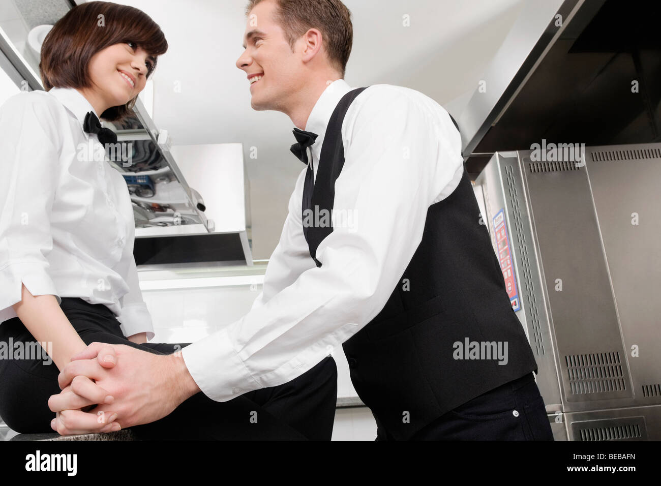 Waiter and waitress romancing in the kitchen Stock Photo - Alamy