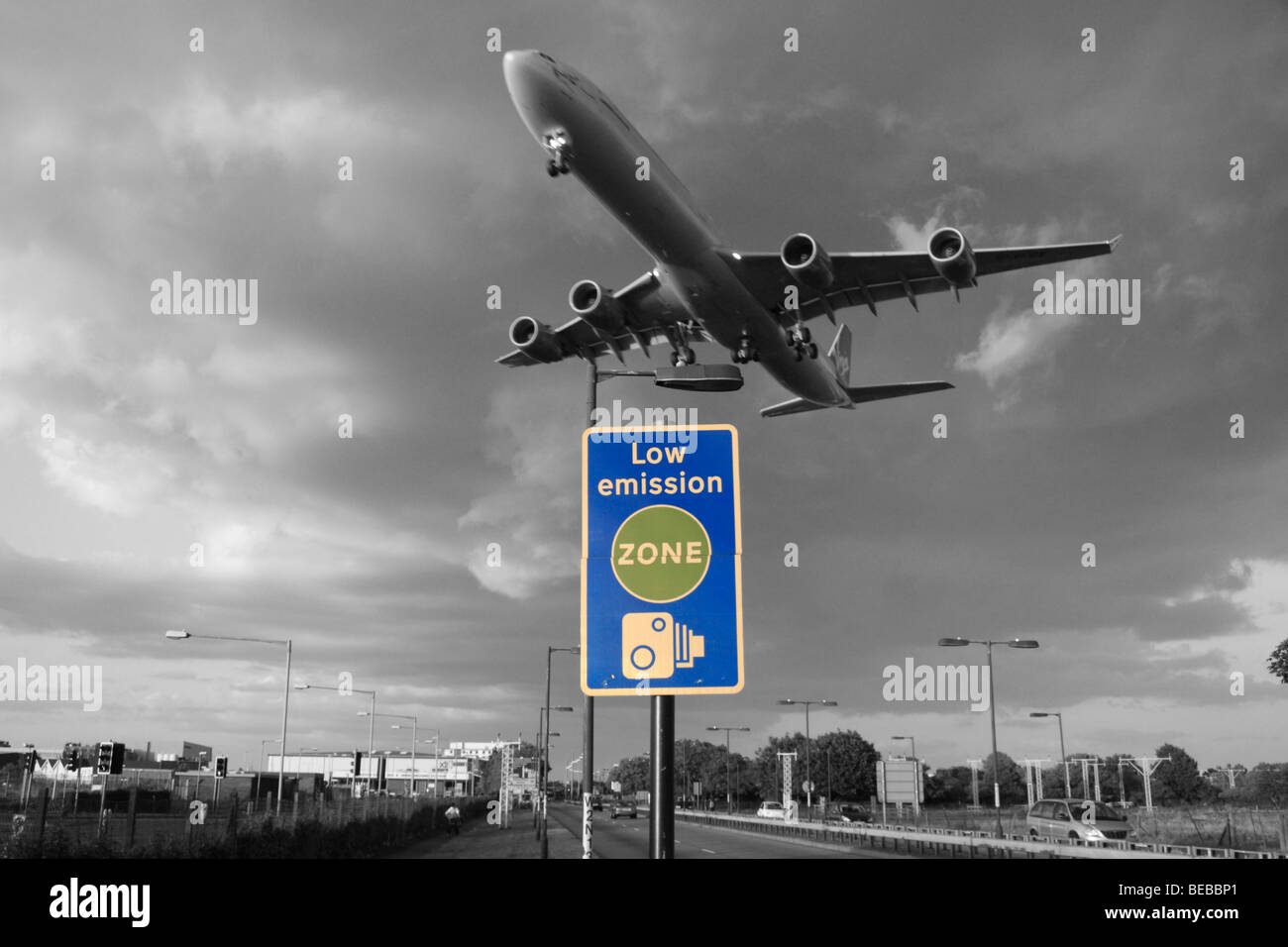 A Virgin Atlantic aircraft passes over a 'Low Emission Zone' road sign ...