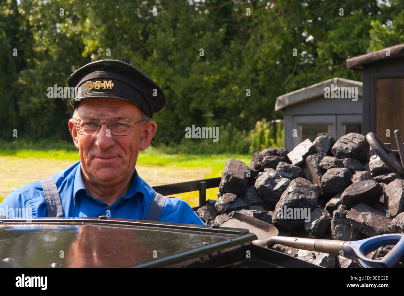 An engine driver on a steam train at Bressingham museum in Norfolk Uk ...