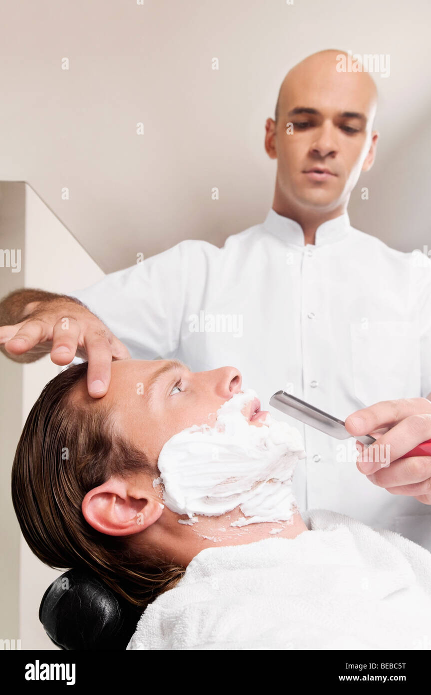 Man getting shaved in a salon Stock Photo - Alamy