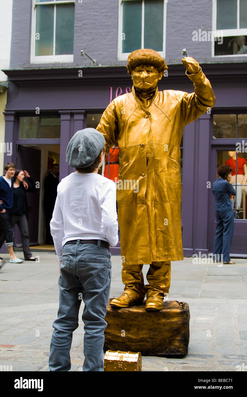 Boy watches street performer in Covent Garden, London Stock Photo - Alamy