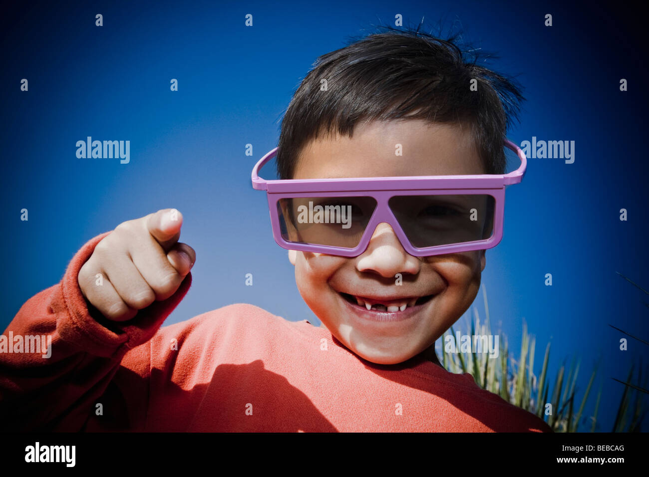 Boy looking up indicating hand hi-res stock photography and images - Alamy