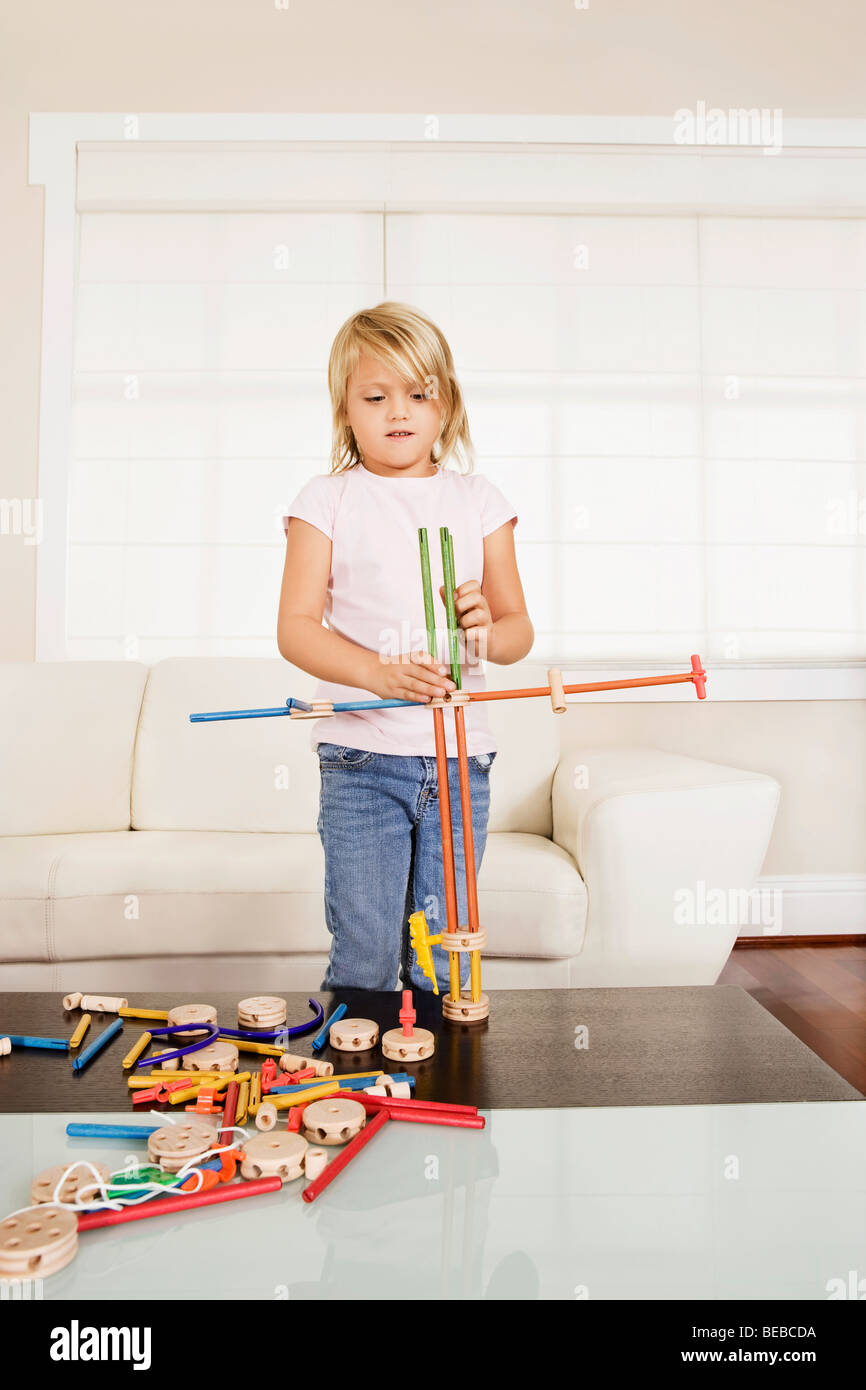 Girl assembling a toy Stock Photo - Alamy