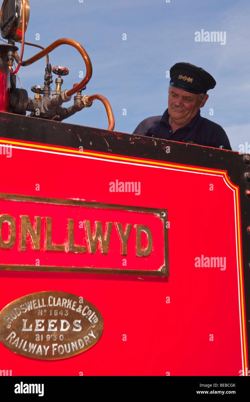 An engine driver on a steam train at Bressingham museum in Norfolk Uk ...