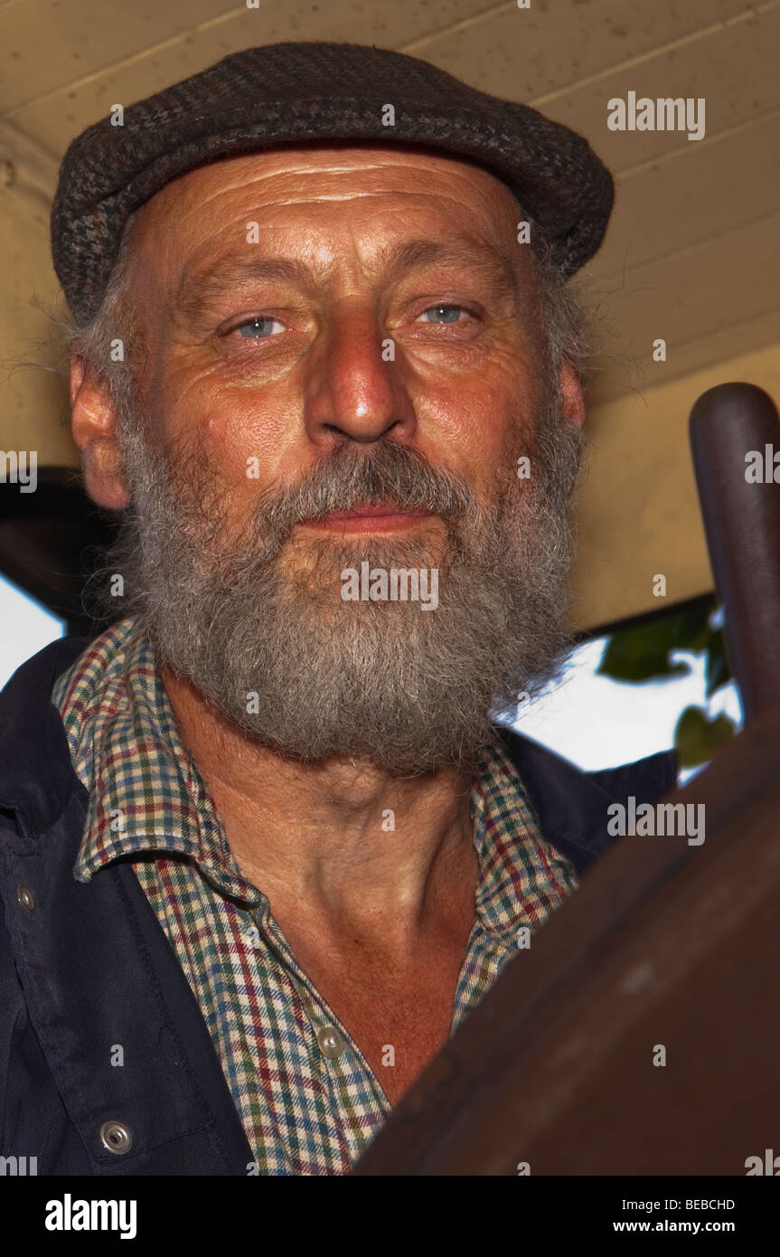 An engine driver on a steam engine at Bressingham museum in Norfolk Uk ...