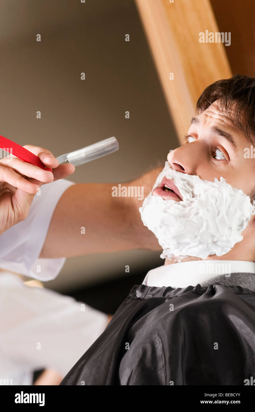 Man getting shaved in a salon Stock Photo - Alamy