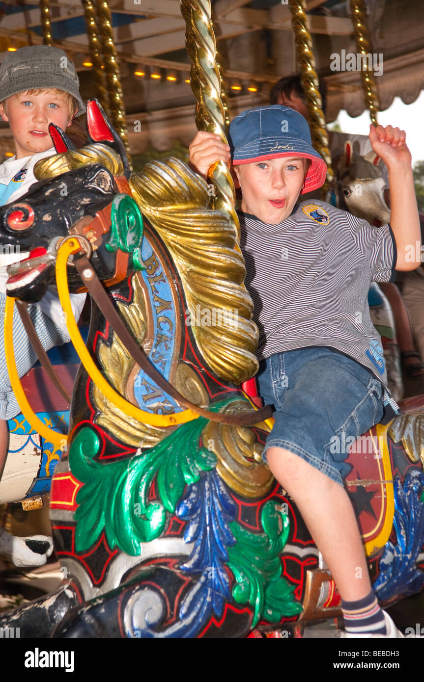 Children on a roundabout at a fun fair hi-res stock photography and ...