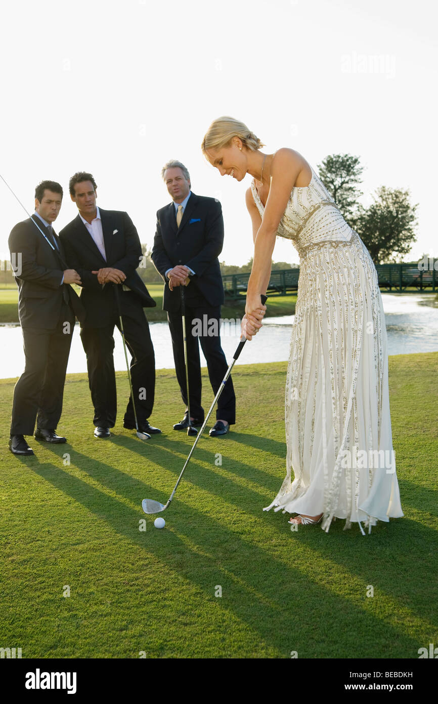 Bride playing golf and three men watching her, Biltmore Golf Course ...