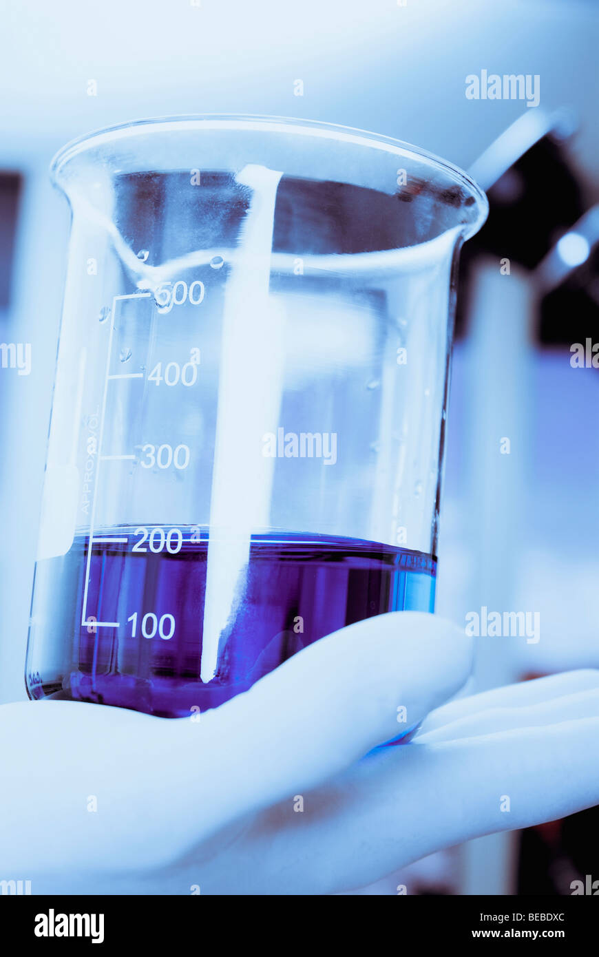 Close up of a person holding a beaker hi-res stock photography and ...