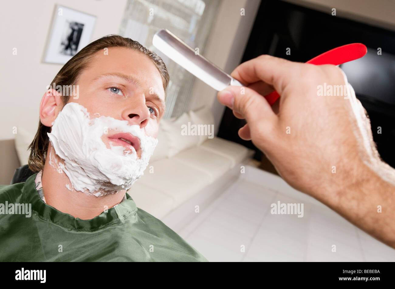 Man getting shaved in a salon Stock Photo - Alamy