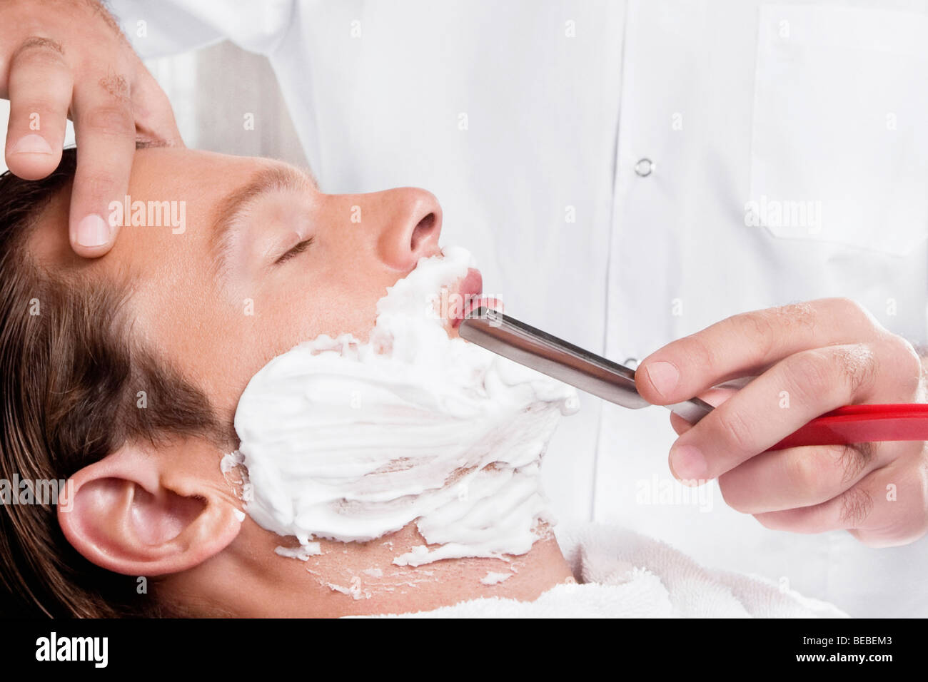 Man getting shaved in a salon Stock Photo - Alamy
