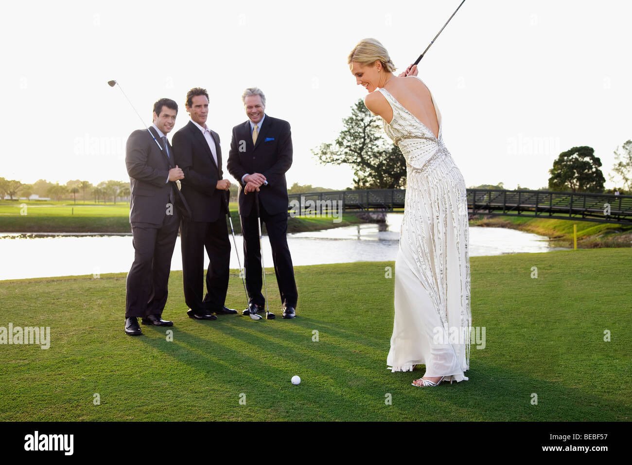 Bride playing golf and three men watching her, Biltmore Golf Course ...