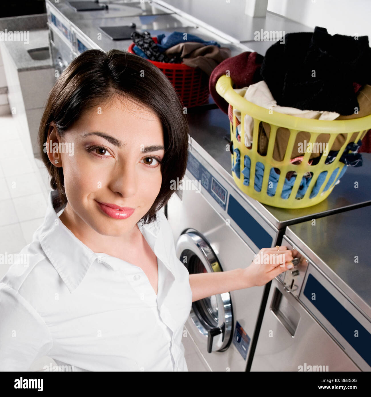 Young woman holding her head washing machine hi-res stock photography ...