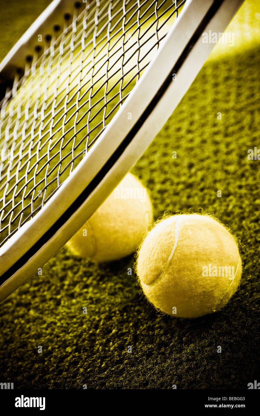 Close-up of a tennis racket and tennis balls in a court Stock Photo - Alamy