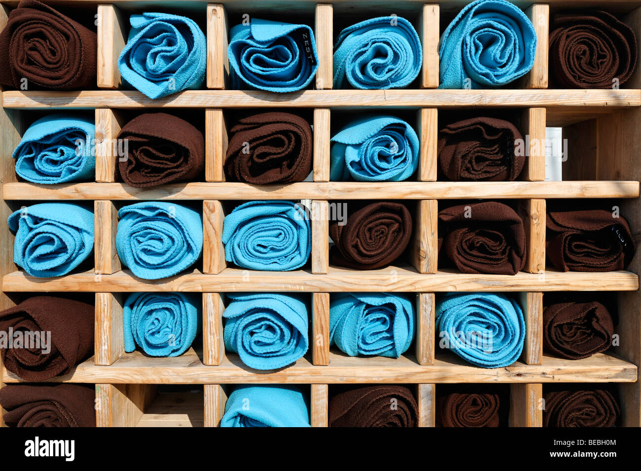 Wooden shelf with rolled blankets for guests feeling cold, terrace of a ...