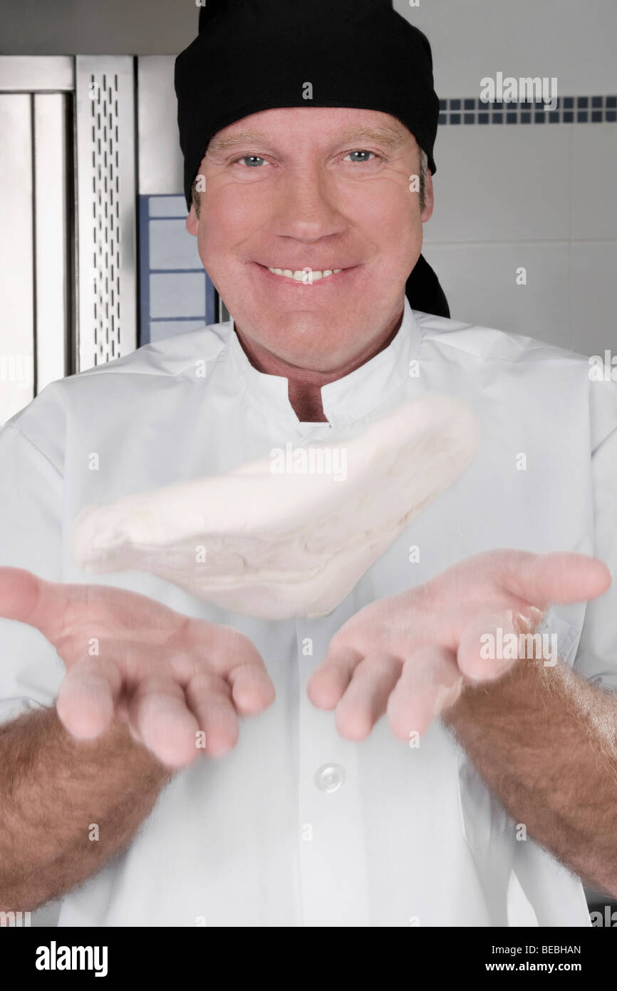 Portrait of chef throwing pizza dough Stock Photo - Alamy