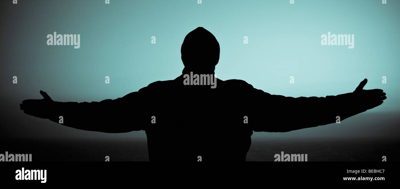 Silhouette of a man standing with his arms outstretched, San Francisco ...