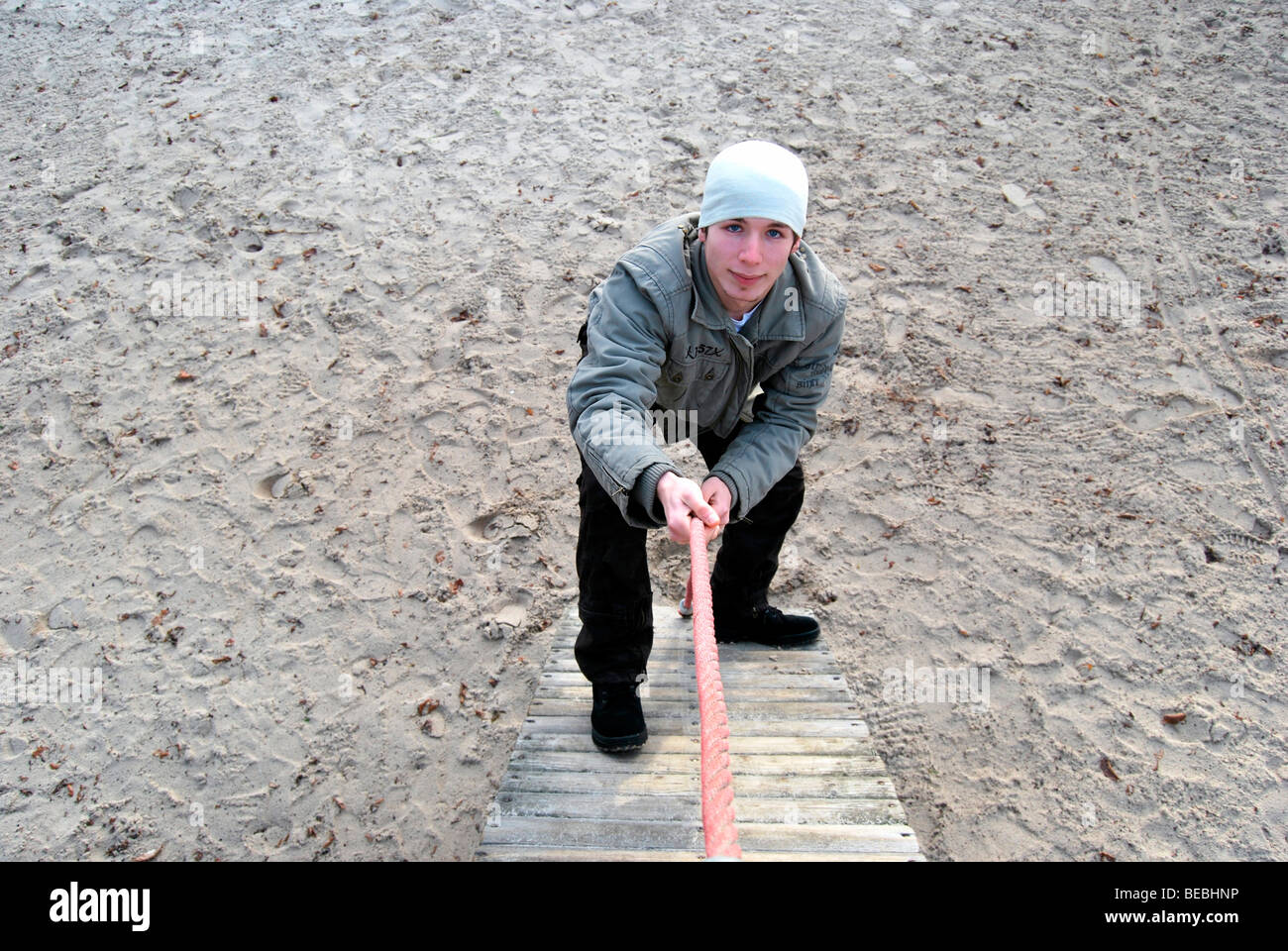 Teenager, 18 years old, climbing up a rope Stock Photo - Alamy