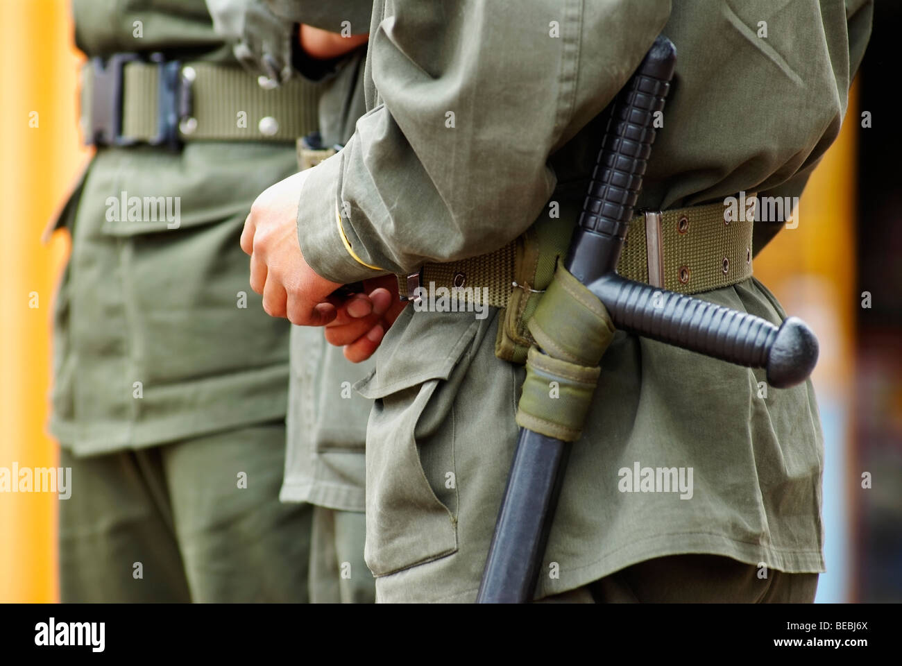 Mid section view of three policemen standing in a row Stock Photo - Alamy